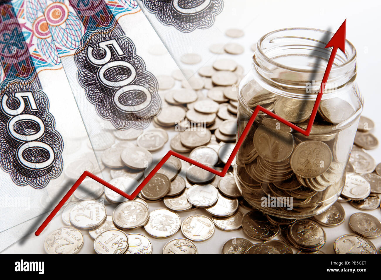 business still life of money bills and coins with a bank and a graph of ...