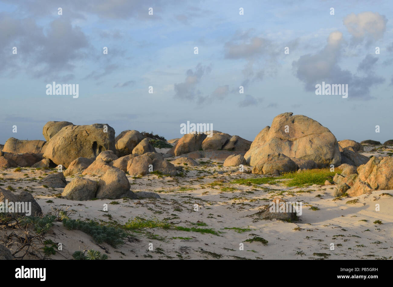 Large limestone rock formations on the white sand beach on Aruba's ...
