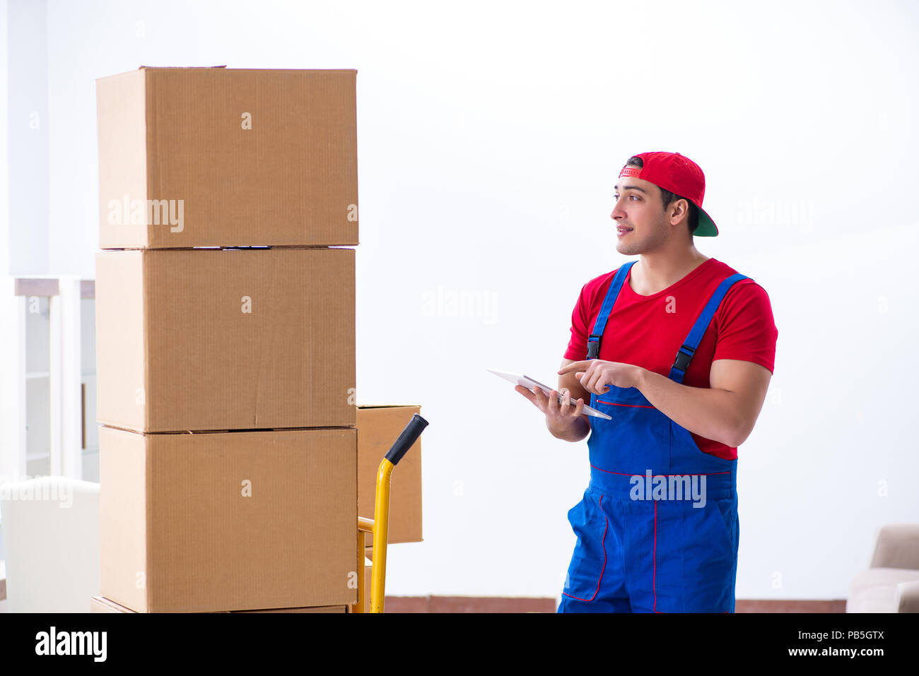 Contractor worker moving boxes during office move Stock Photo - Alamy