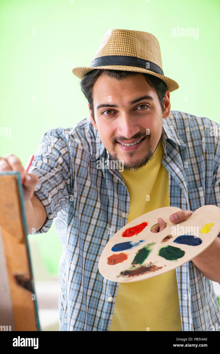 Young male artist working on new painting in his studio Stock Photo - Alamy