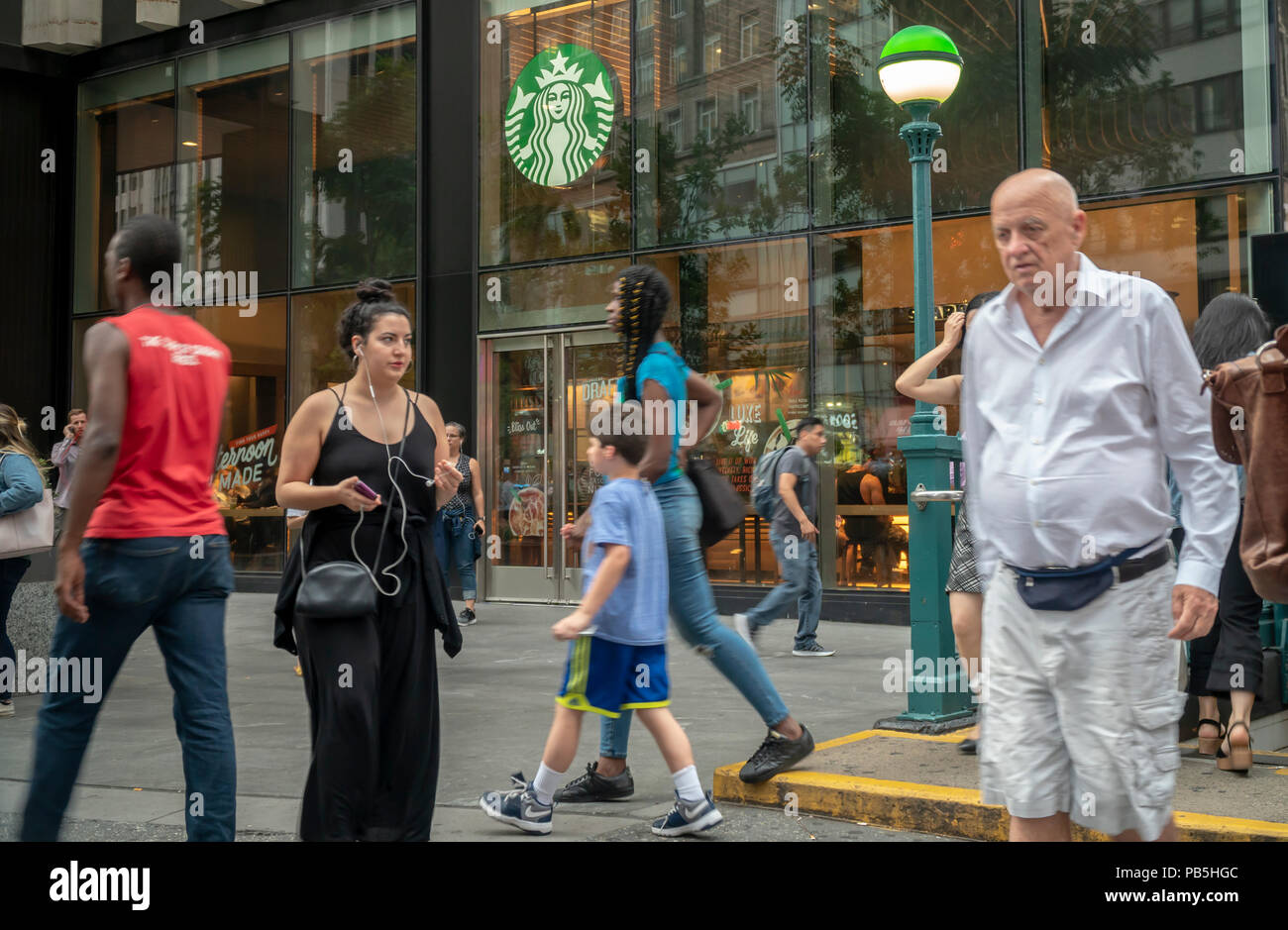 Passer-by exit the subway in front of a Starbucks coffee shop in ...