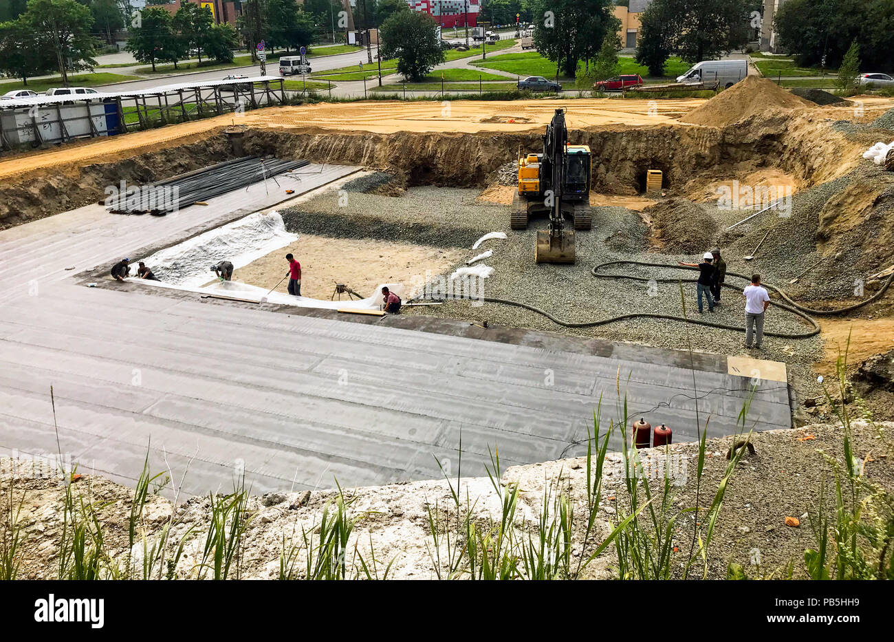 Foundation ditch with construction machinery at construction site ...