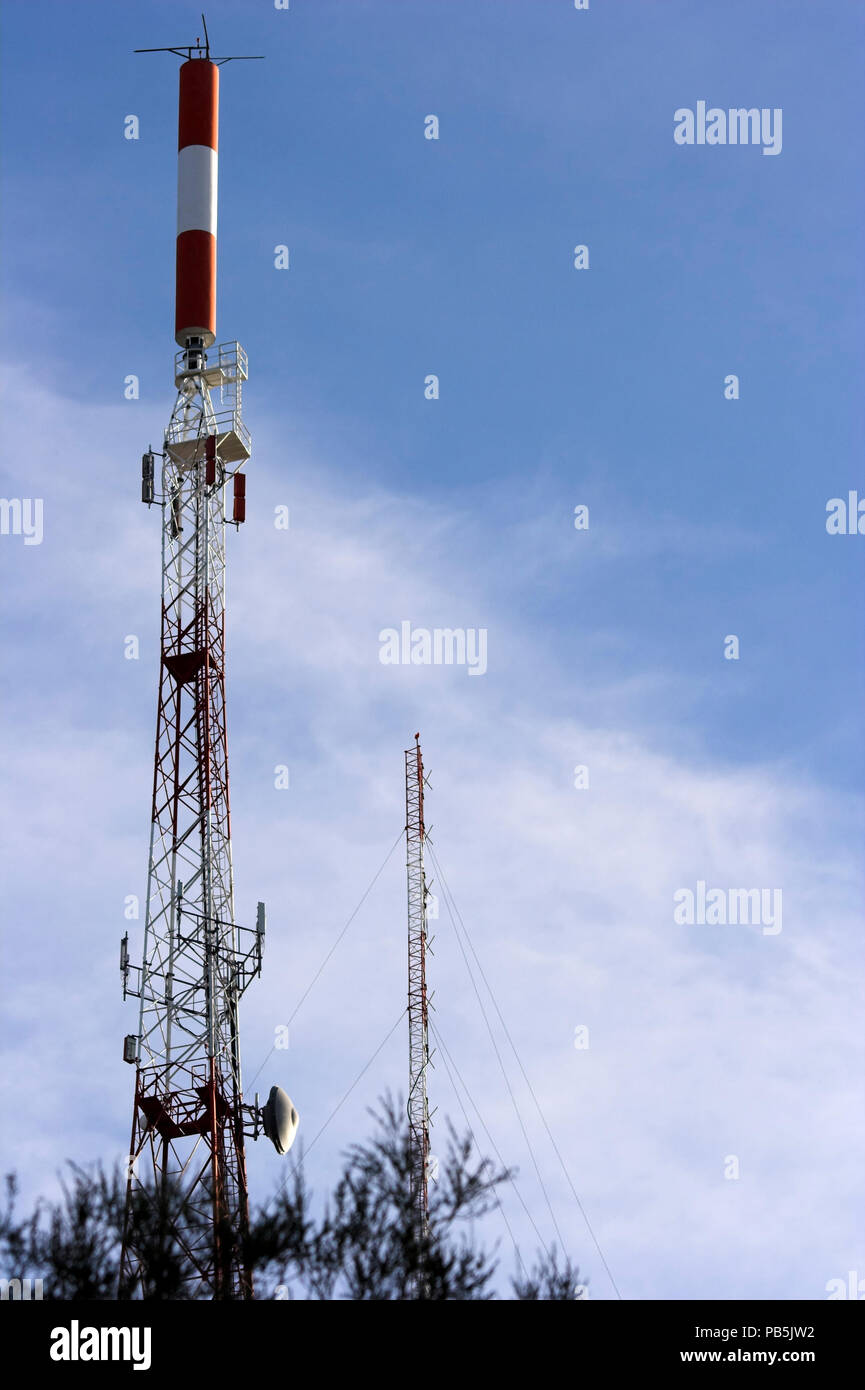 Composition with red and white towers of communication with their ...