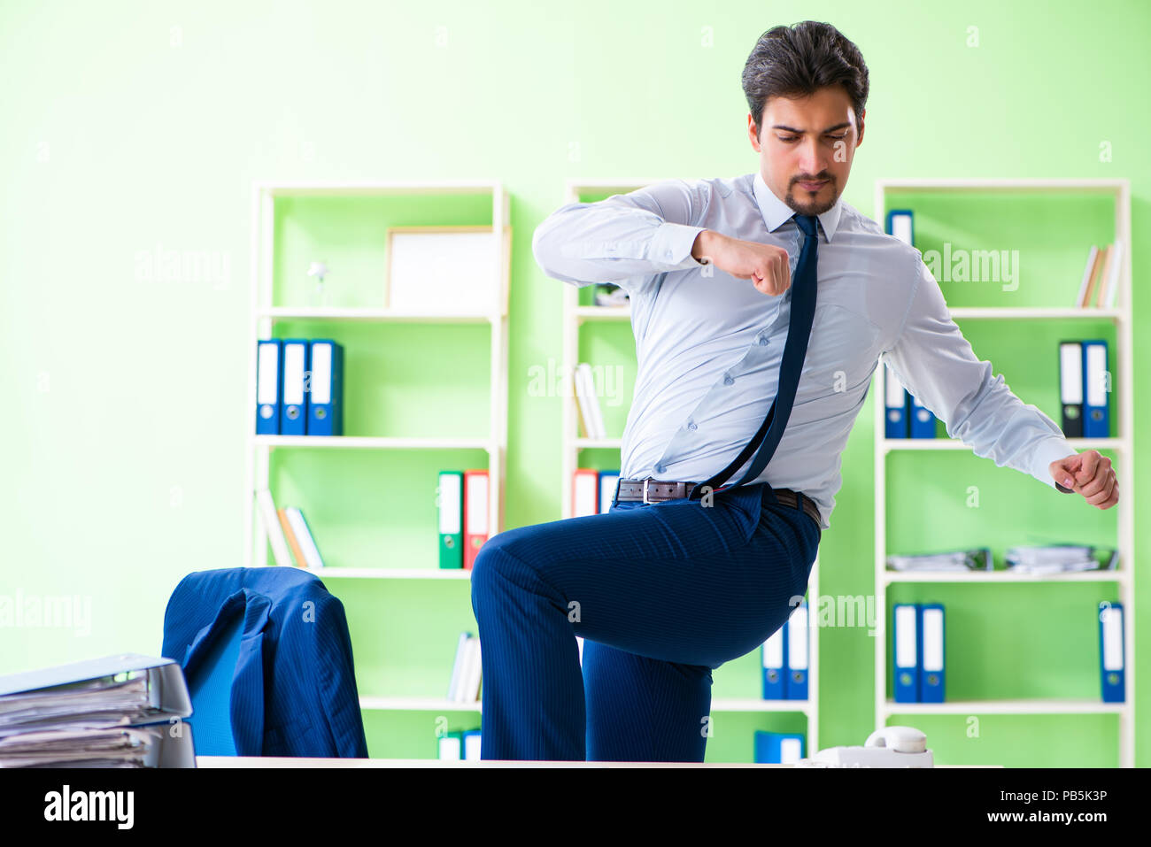 Employee doing exercises during break at work Stock Photo - Alamy