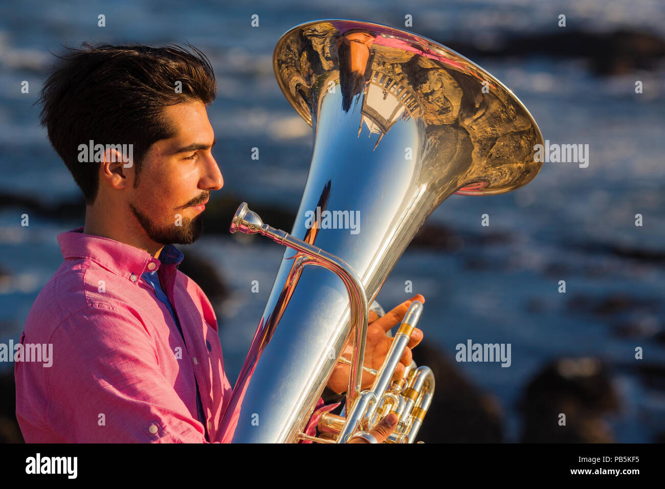 Musician play to Tuba on romantic sea shore Stock Photo - Alamy