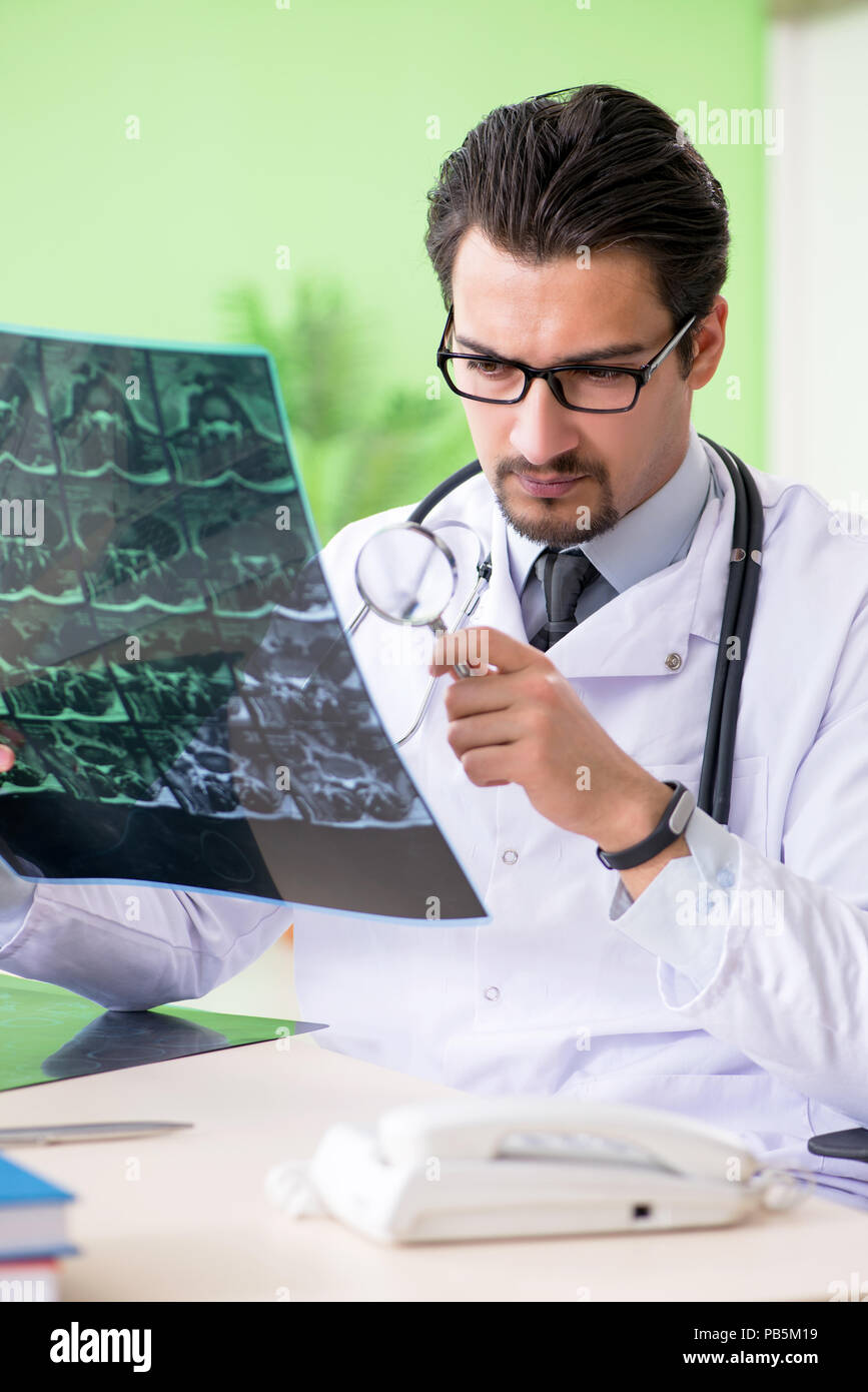 Doctor radiologist looking at x-ray scan in hospital Stock Photo - Alamy