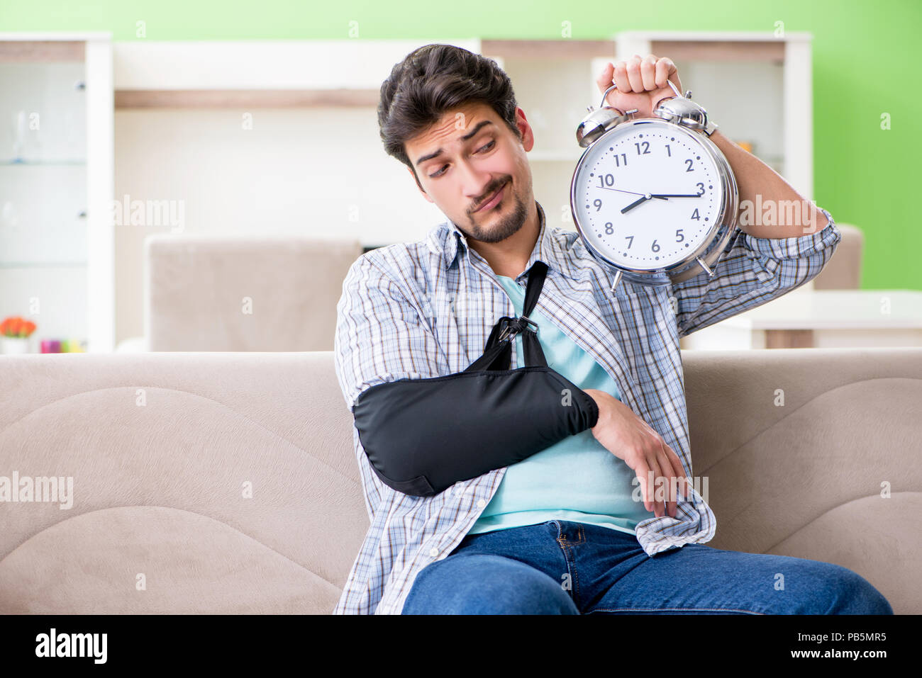 Young student man with hand injury in time management concept Stock ...