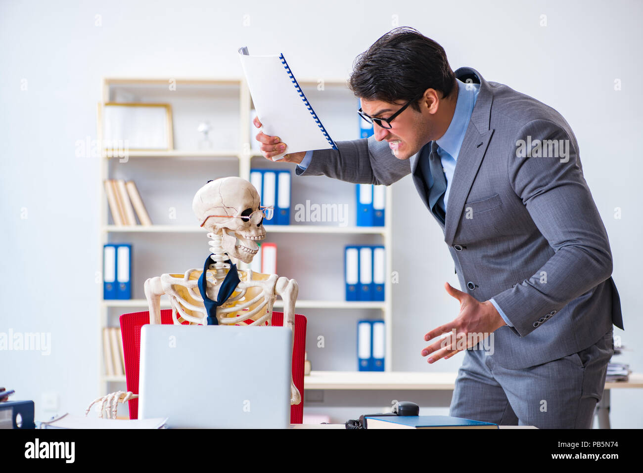 Angry boss yelling at his skeleton employee Stock Photo - Alamy