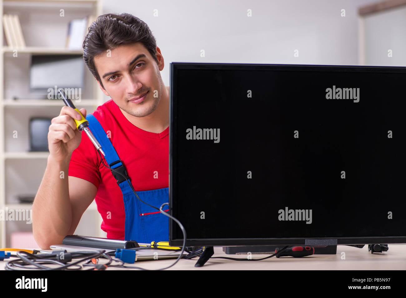 Professional repair engineer repairing broken tv Stock Photo - Alamy