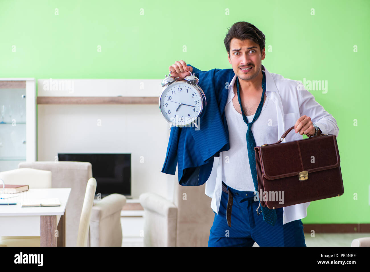 Man dressing up and late for work Stock Photo - Alamy