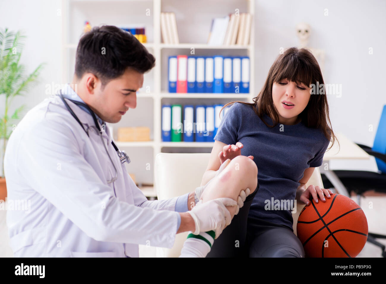 Female basketball player visiting doctor after injury Stock Photo - Alamy
