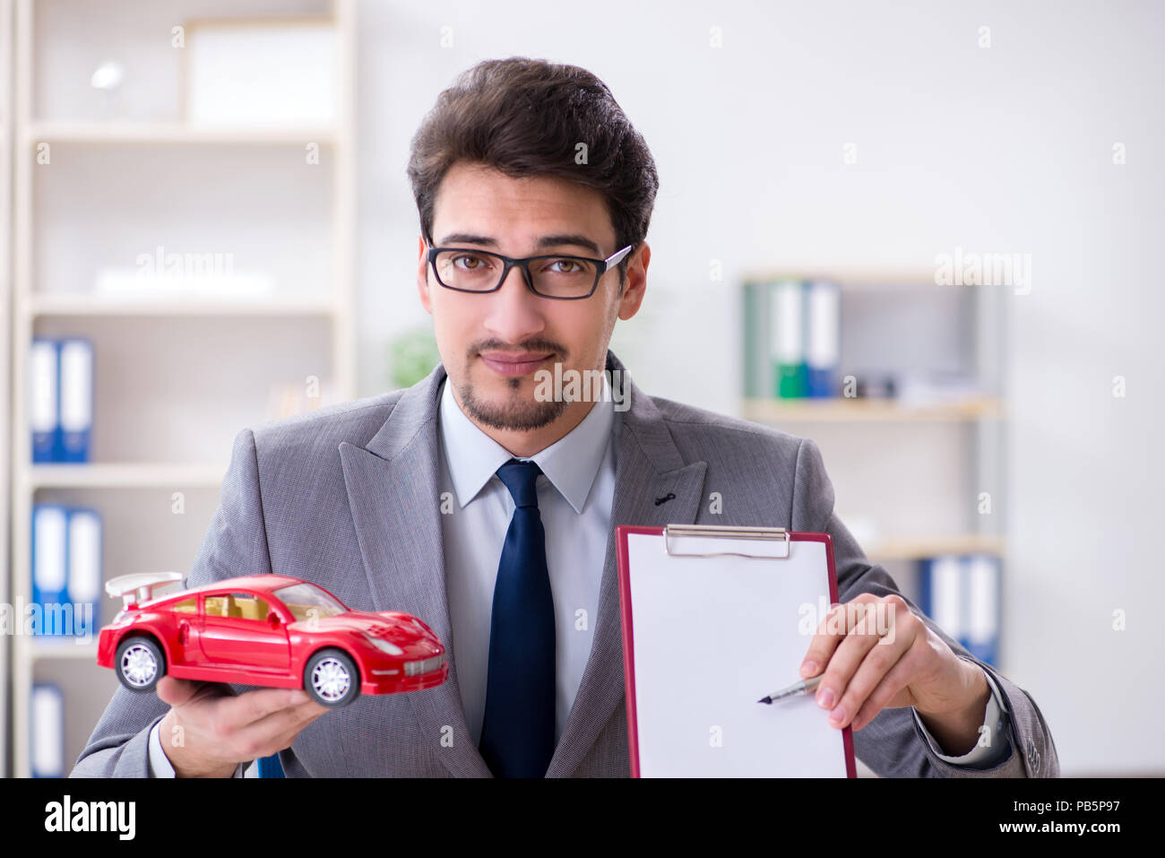 Agent offering car motor insurance Stock Photo - Alamy