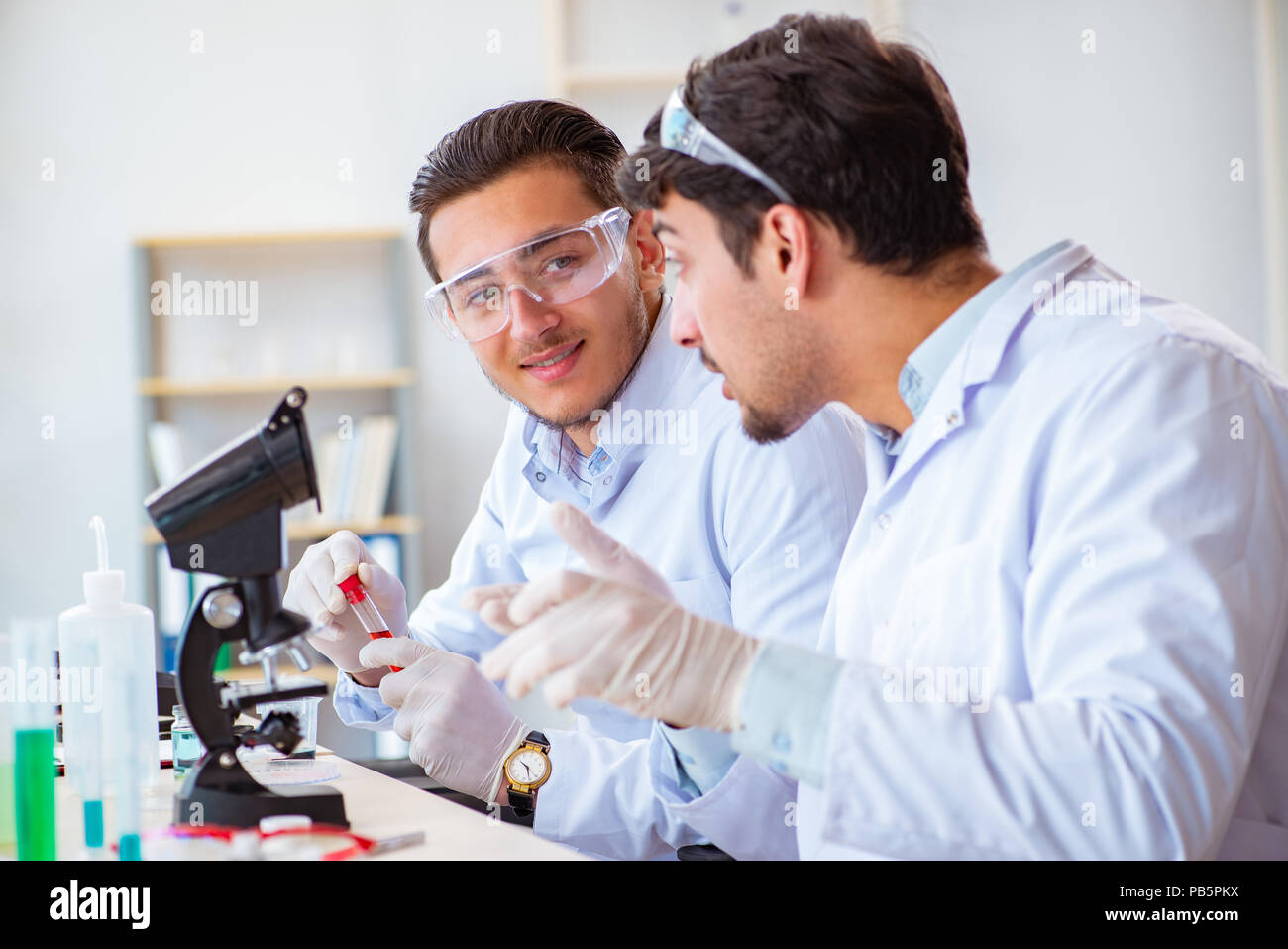 Team of chemists working in the lab Stock Photo - Alamy