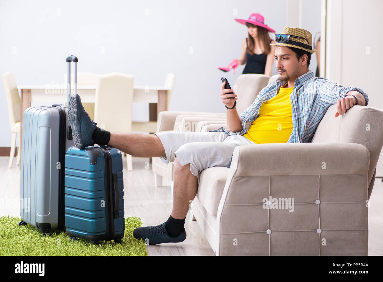 Young family packing for vacation travel Stock Photo - Alamy