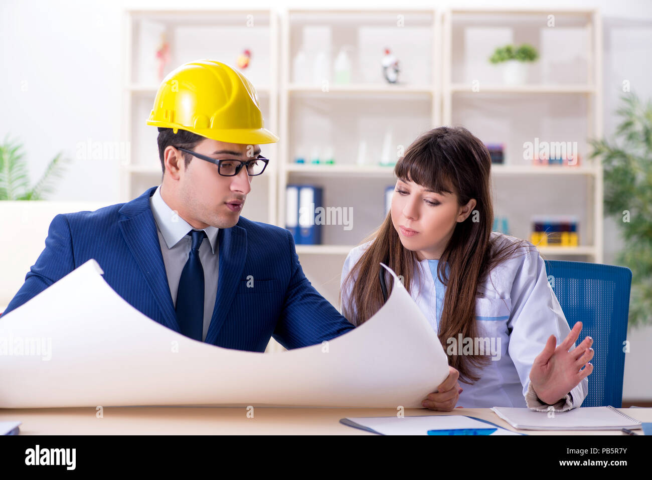 Doctor discussing new hospital plan with architect Stock Photo - Alamy