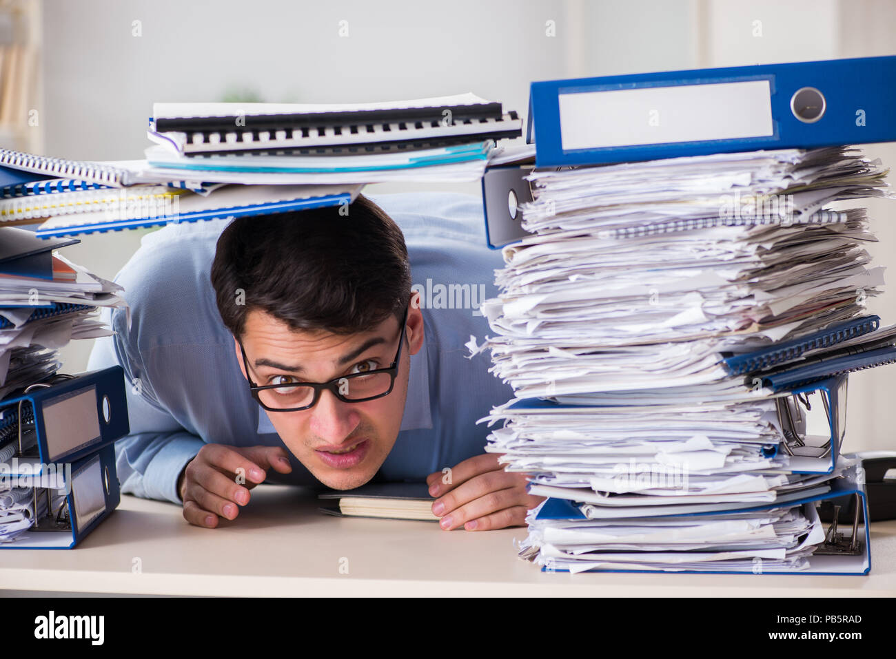 Extremely busy businessman working in office Stock Photo - Alamy