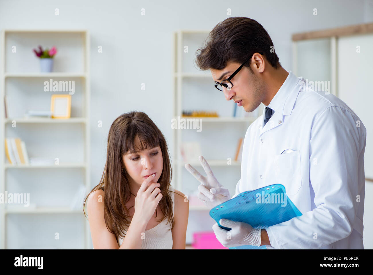 Doctor examining the skin of female patient Stock Photo - Alamy