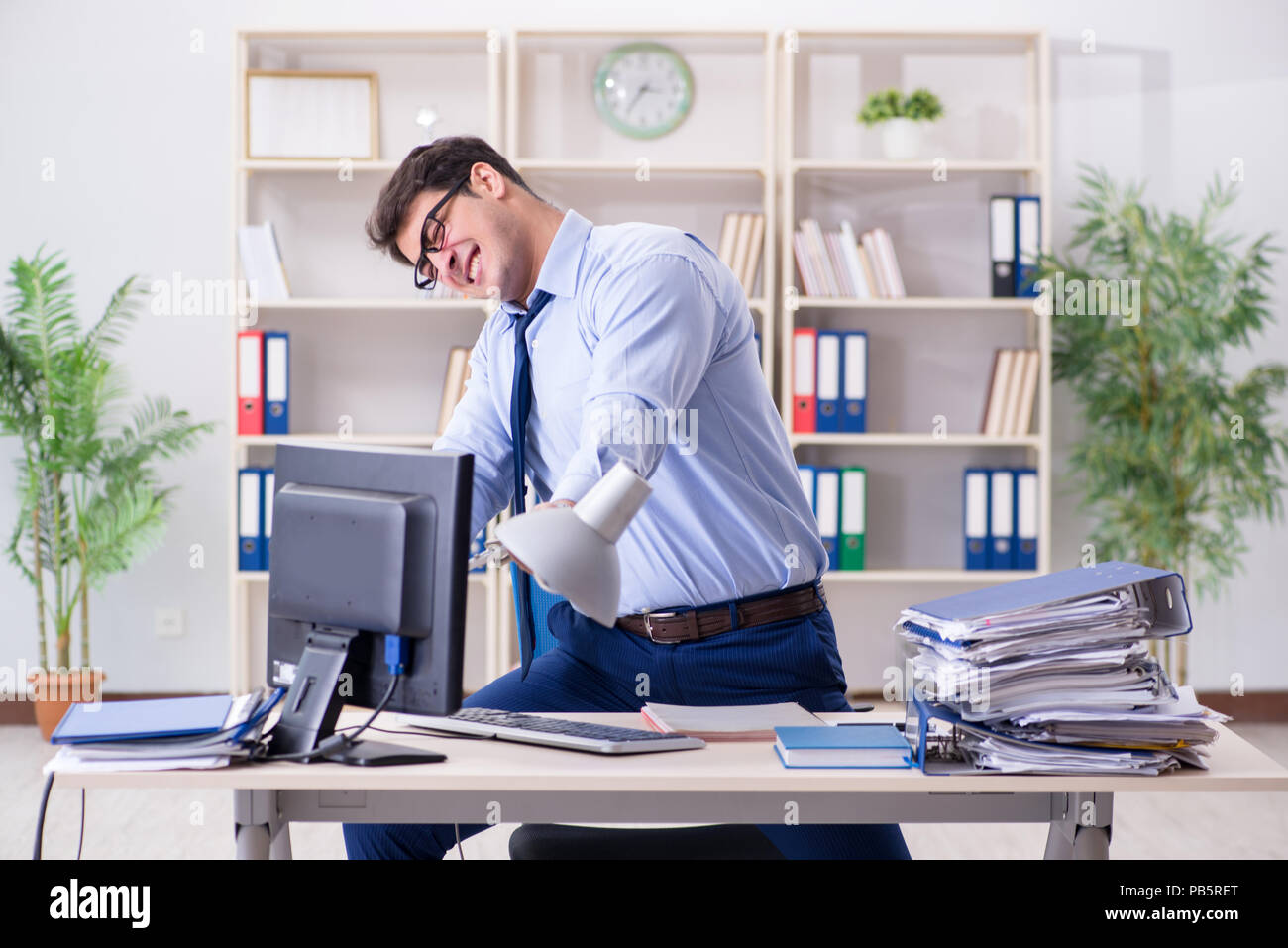 Angry businessman frustrated with too much work Stock Photo - Alamy