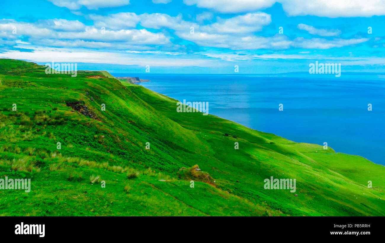 Aerial view over the green coastline and cliffs on the Isle of Skye in ...