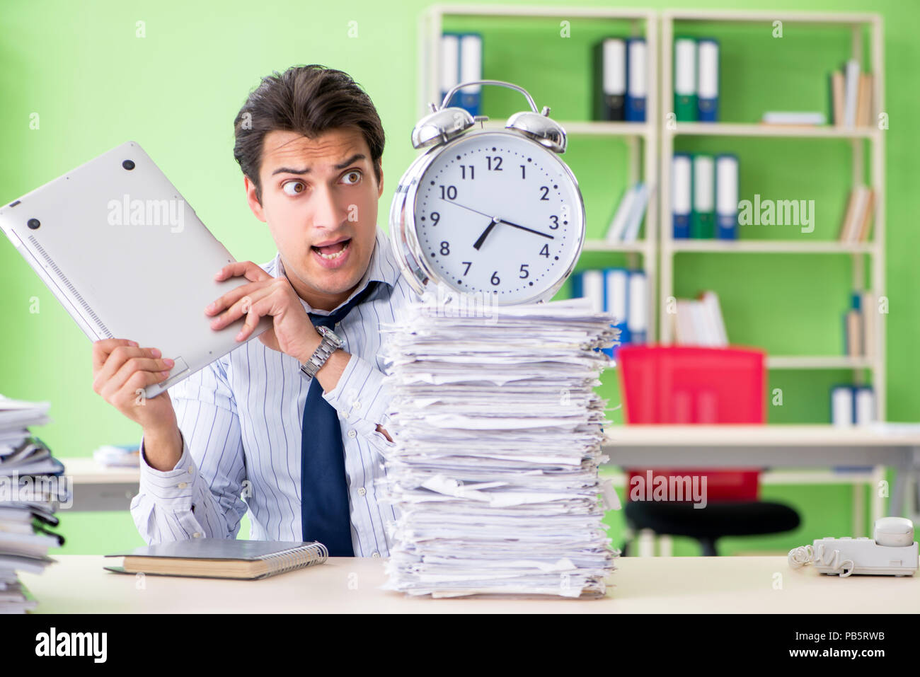 Businessman having problems with paperwork and workload Stock Photo - Alamy