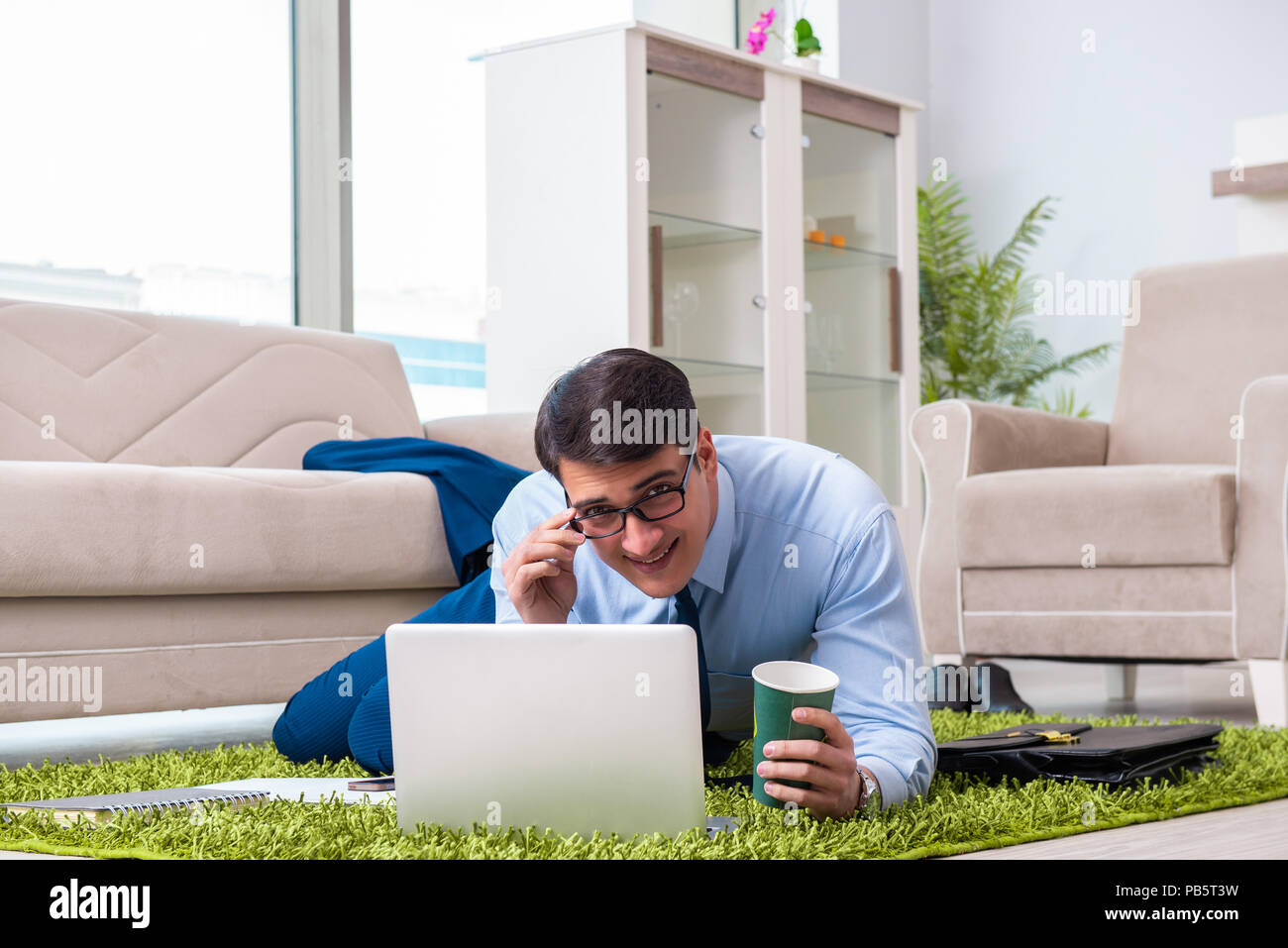 Businessman taking work home and working overtime Stock Photo - Alamy