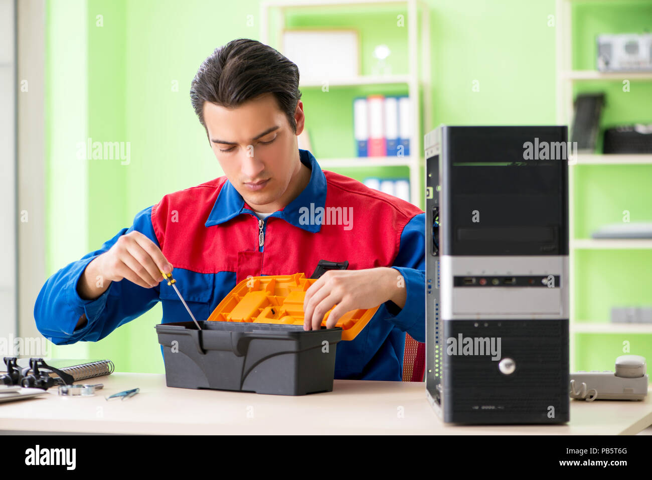 Computer engineer repairing broken desktop Stock Photo - Alamy