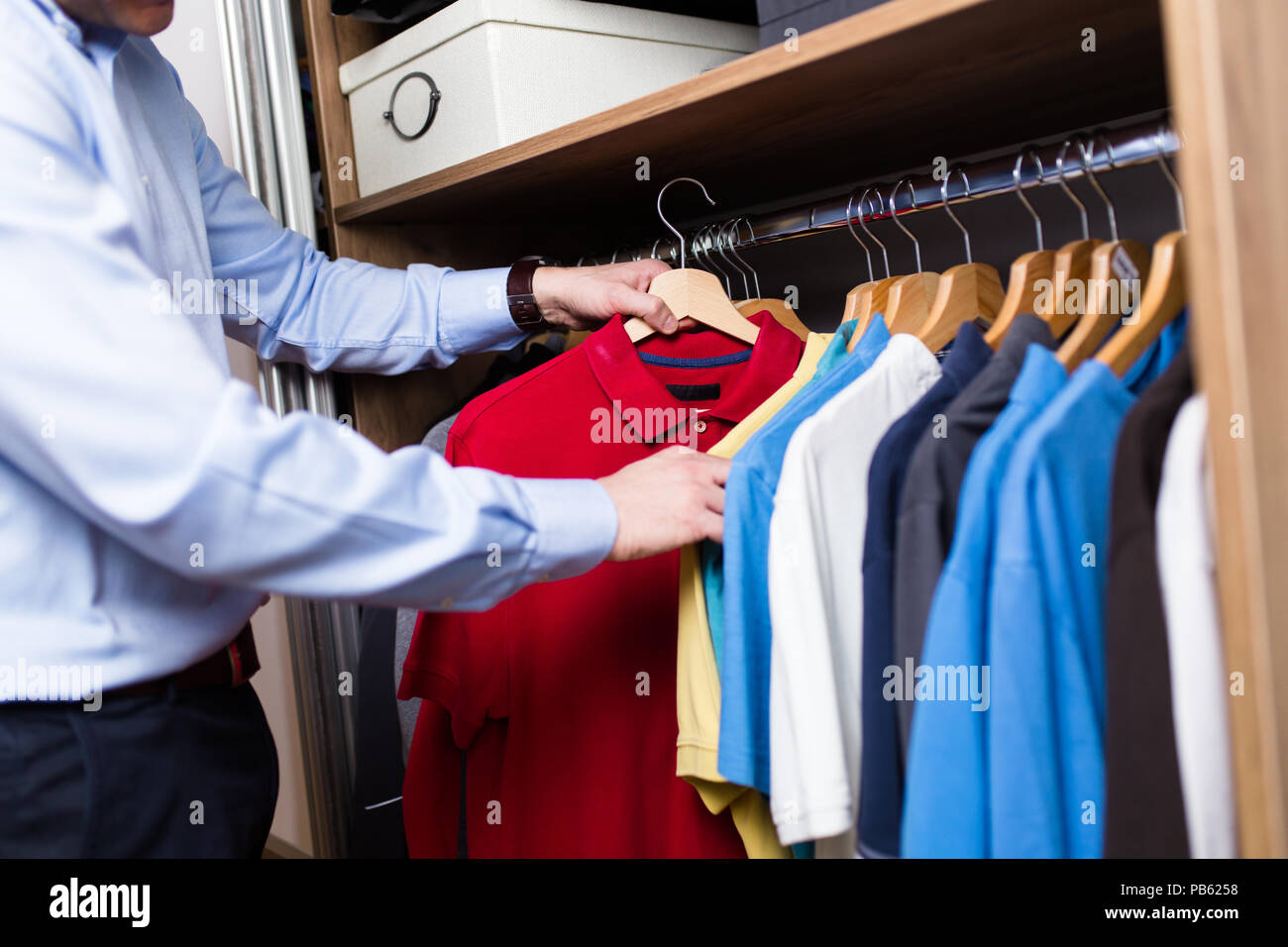 Man choosing shirts hi-res stock photography and images - Alamy