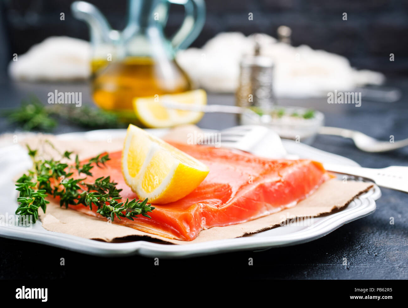 salmon fish on plate with lemon and salt Stock Photo - Alamy