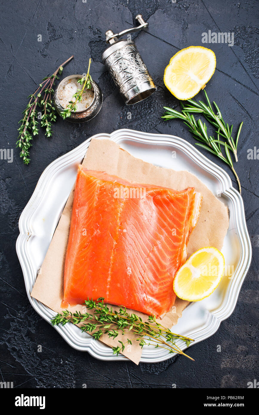salmon fish on plate with lemon and salt Stock Photo - Alamy