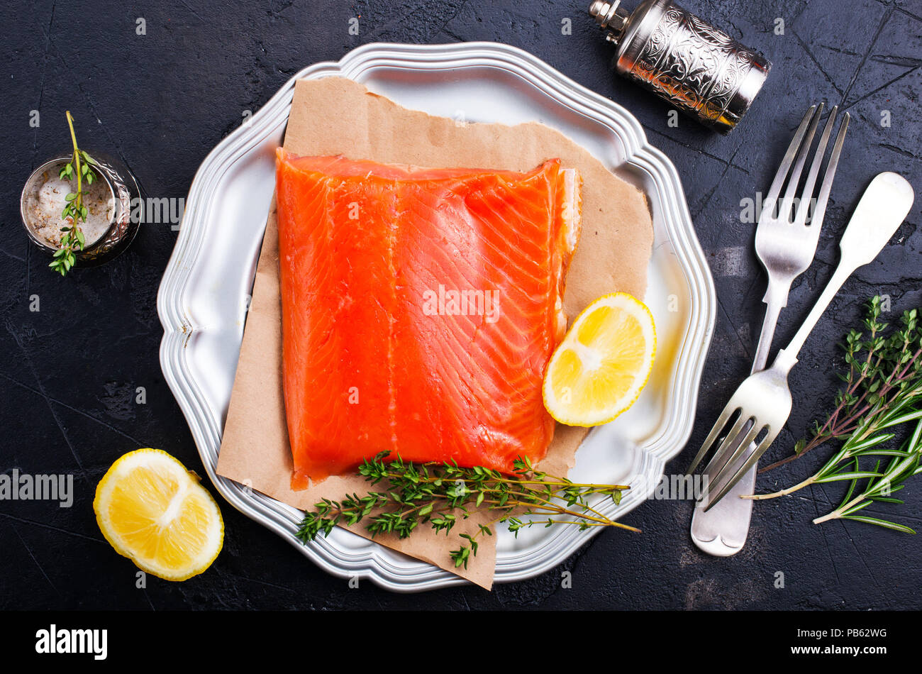 salmon fish on plate with lemon and salt Stock Photo - Alamy