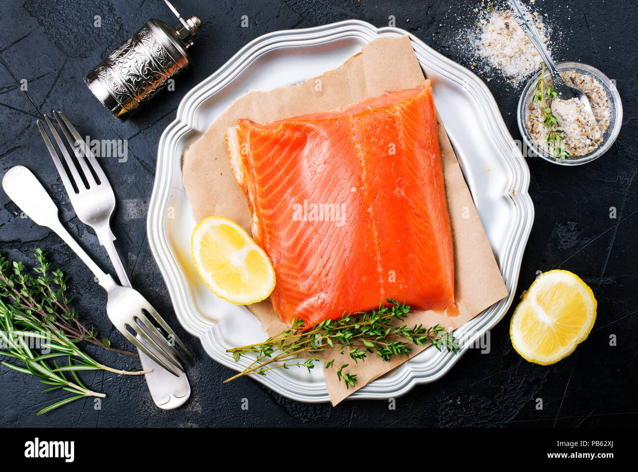 salmon fish on plate with lemon and salt Stock Photo - Alamy