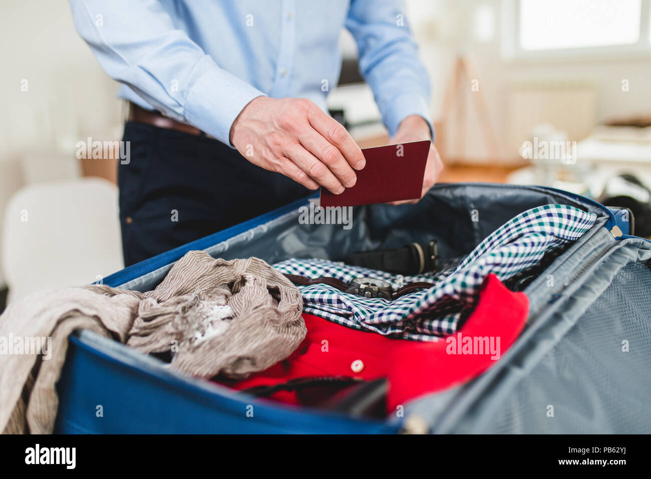 Man preparing for business travelling. Open traveler's bag with ...