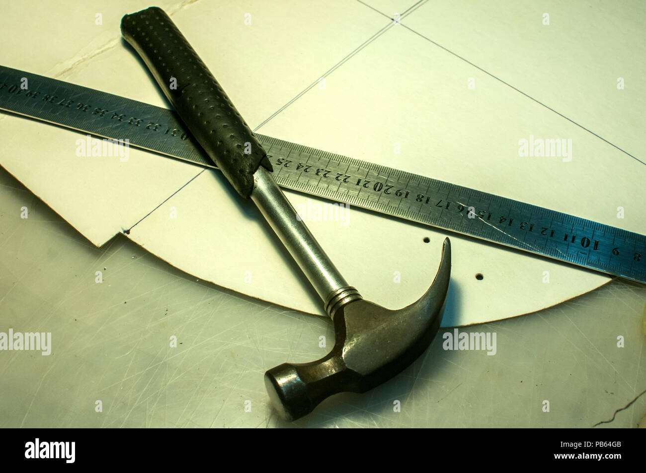 Hammer, metal ruler and cardboard cuts as tools in workshop production ...