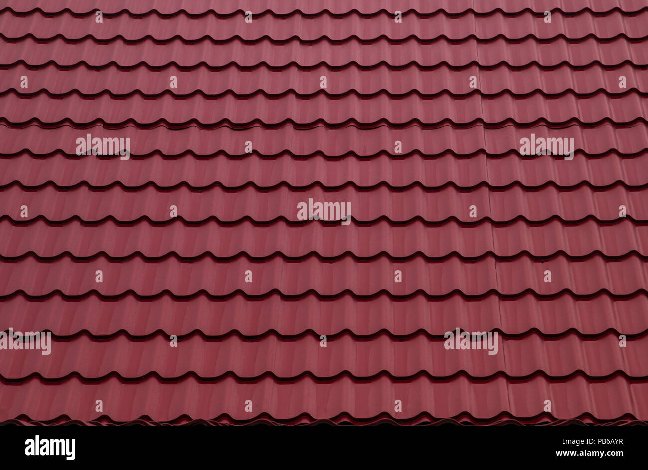 Red roofing from stainless metal plate, metal tile Stock Photo - Alamy