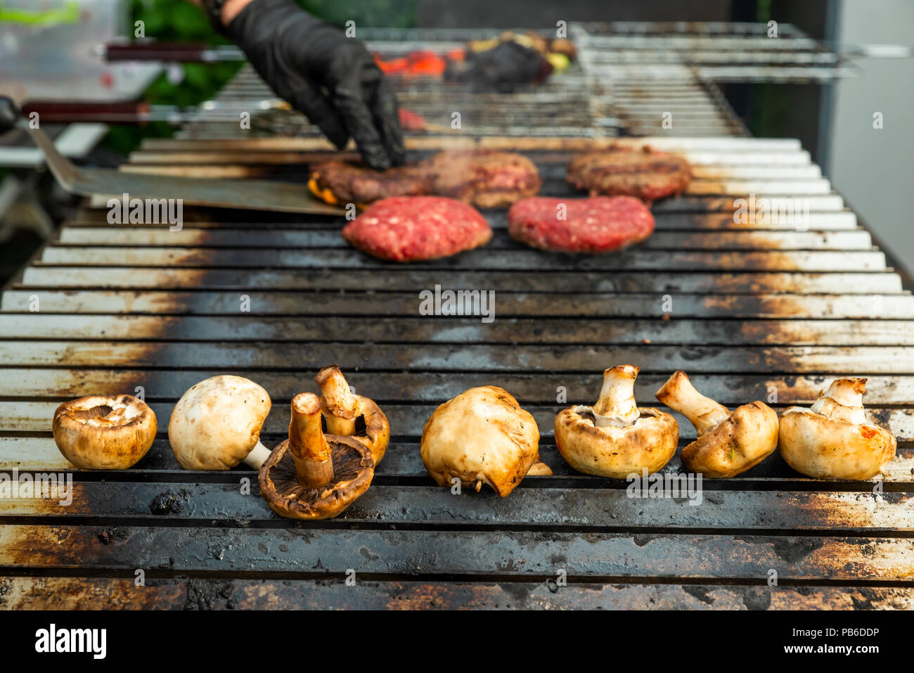 Grilled mushrooms with meat on the stove Stock Photo - Alamy