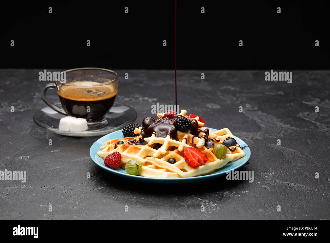 Photo of cup of black coffee with sugar with Viennese waffles with ...