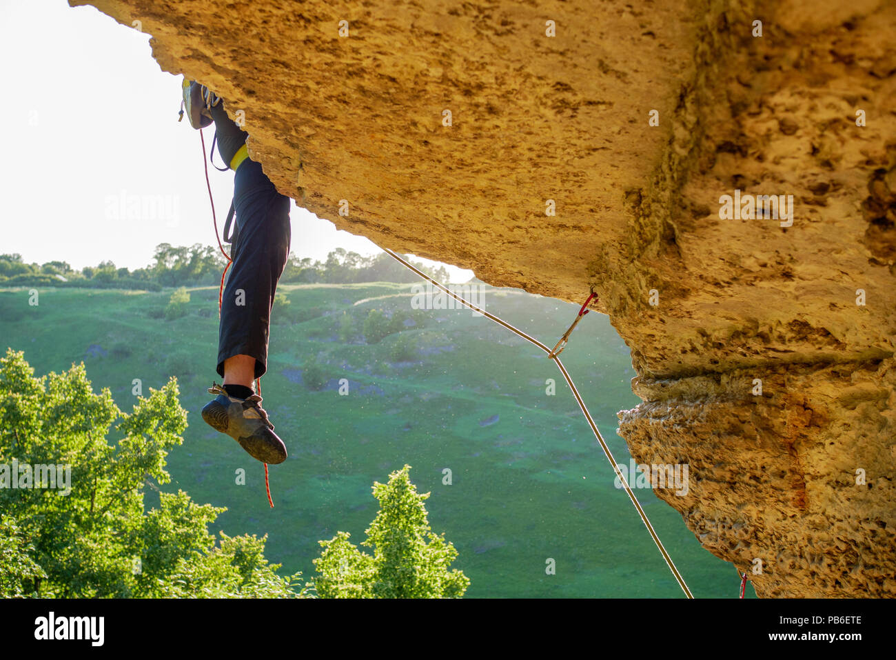 Photo of sporty man climbing rock Stock Photo - Alamy