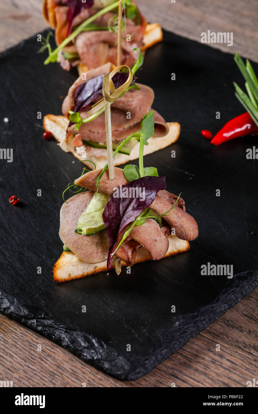 Beef canape served green onion Stock Photo - Alamy