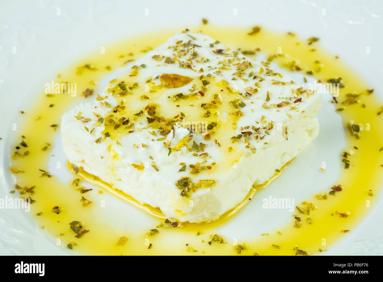 Greek feta cheese with oil and spices Stock Photo - Alamy
