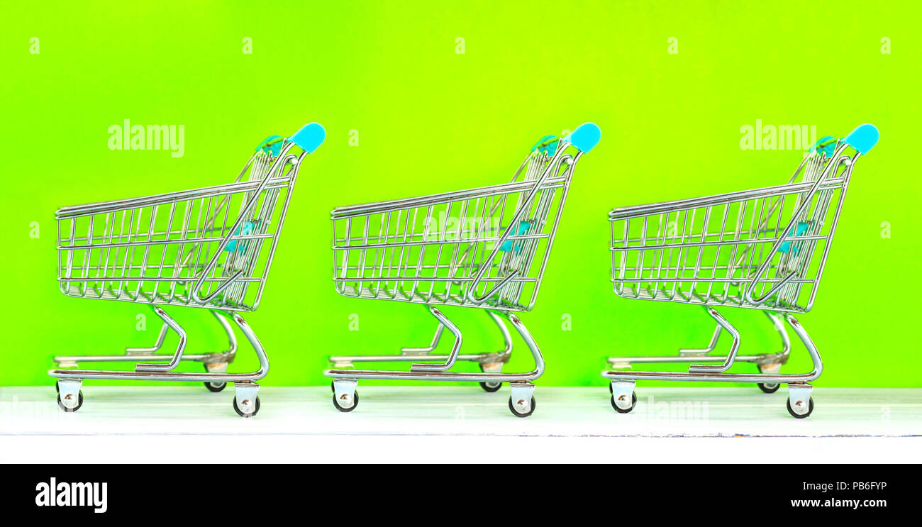 Retail store shopping concept miniature shopping carts on green screen ...