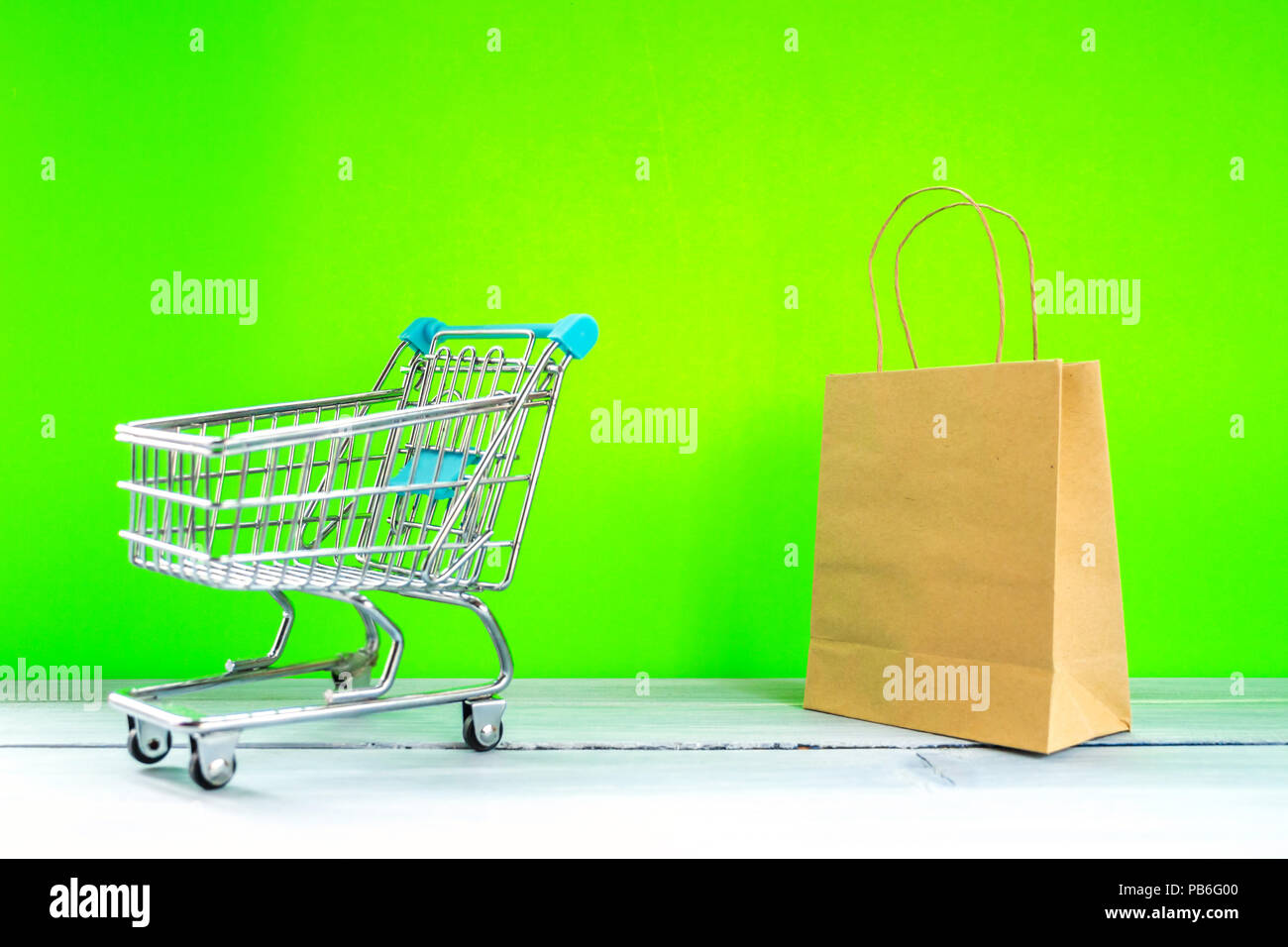Retail store shopping concept miniature shopping carts on green screen ...