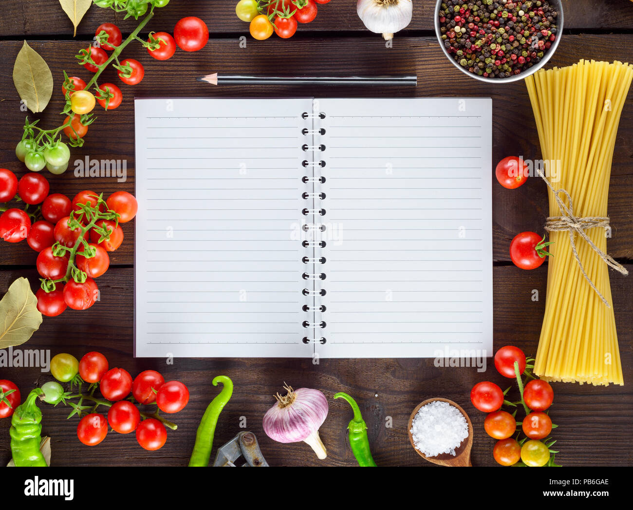 open blank notebook in a line and a black wooden pencil and ingredients ...