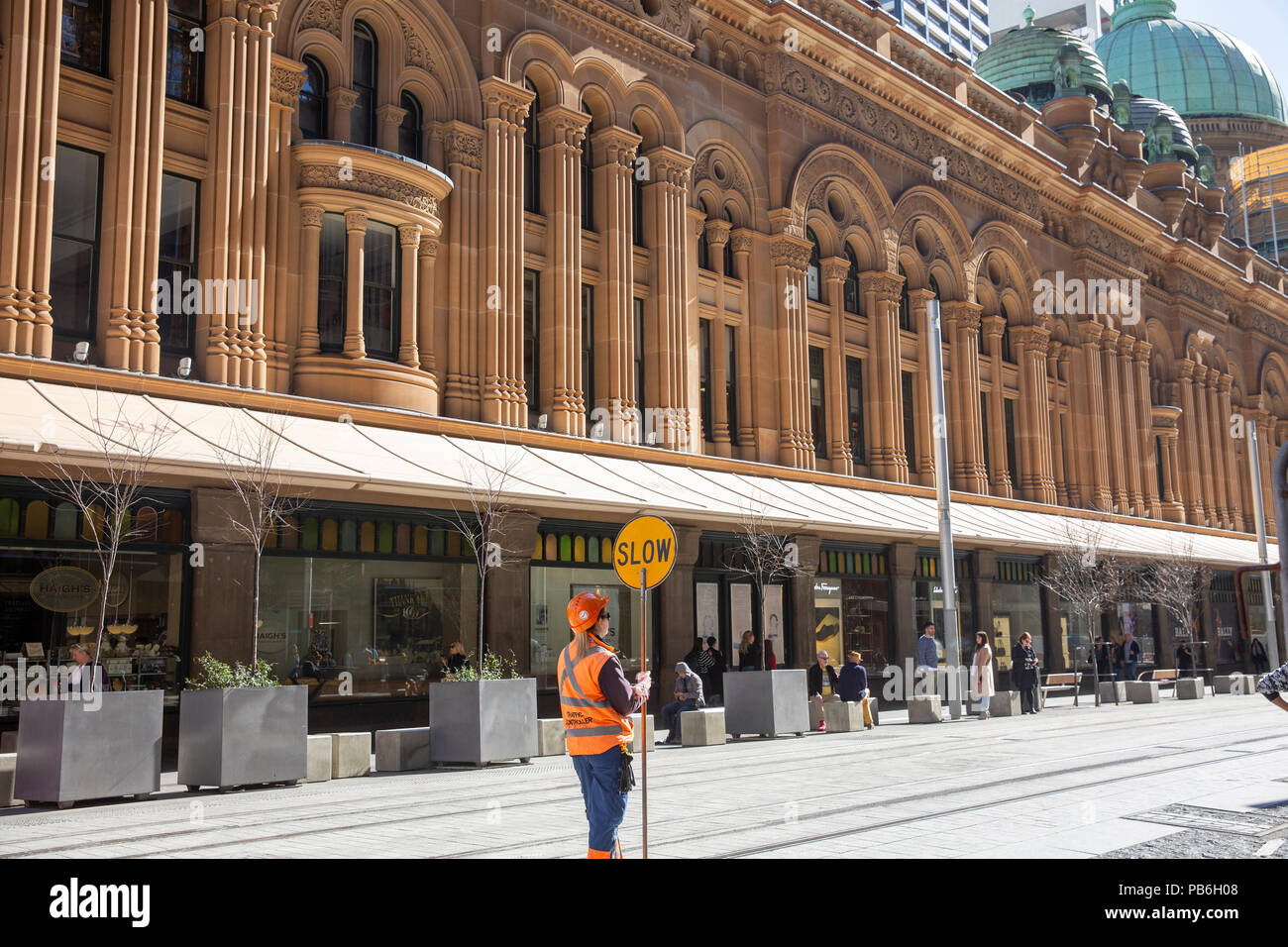 Female traffic controller manages traffic along George street in Sydney ...