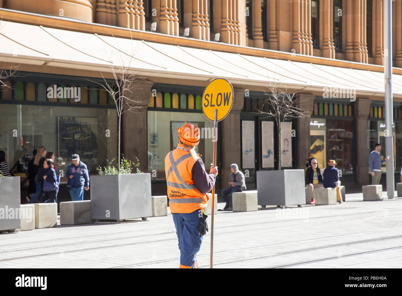 Female traffic controller manages traffic along George street in Sydney ...