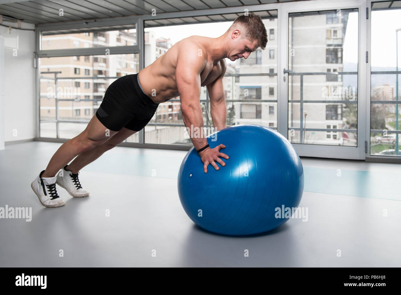 Young Man Athlete Doing Abs Exercise On Ball As Part Of Bodybuilding ...