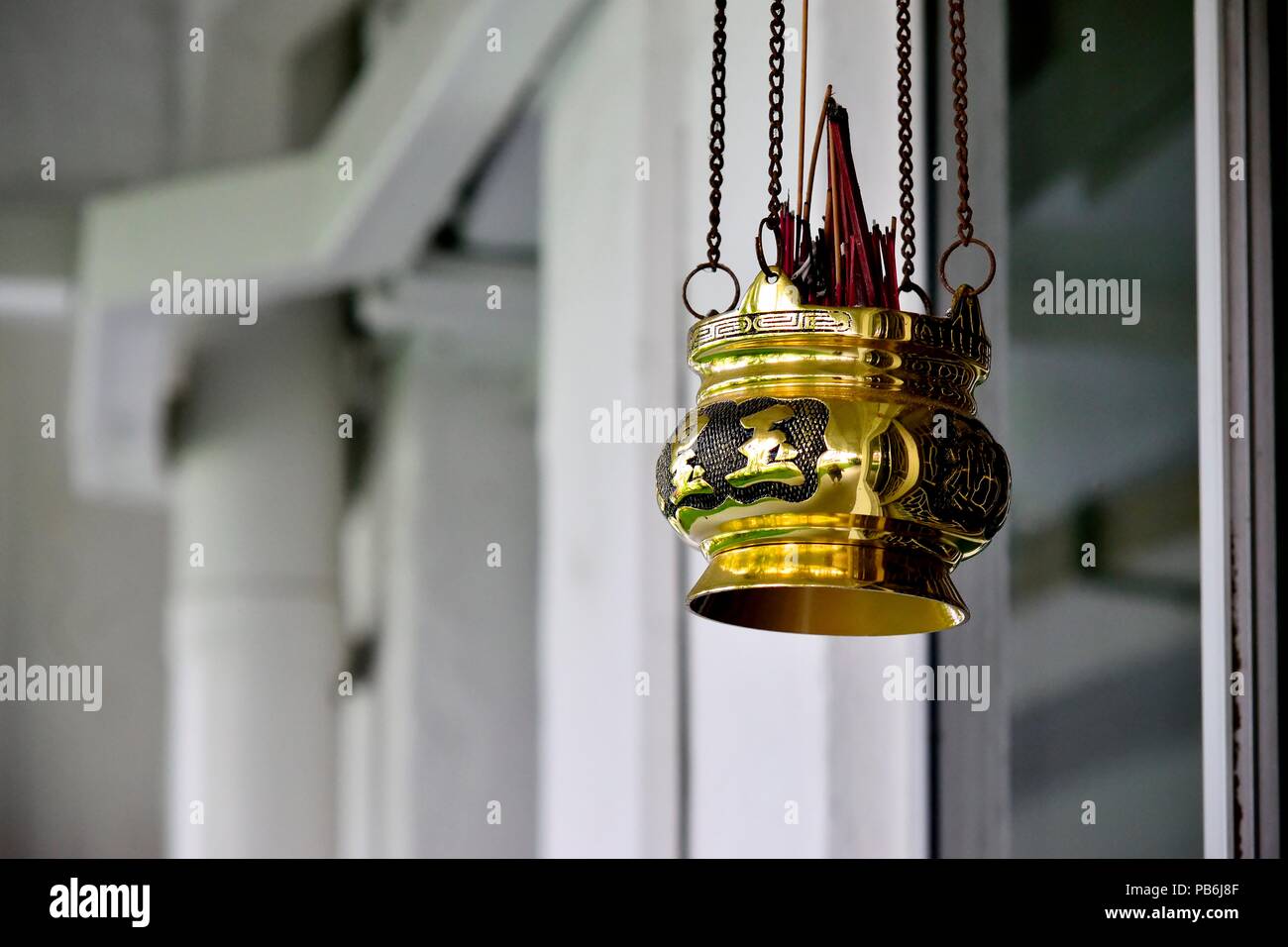 Antique Asian brass incense burner hanging outside a house Stock Photo ...