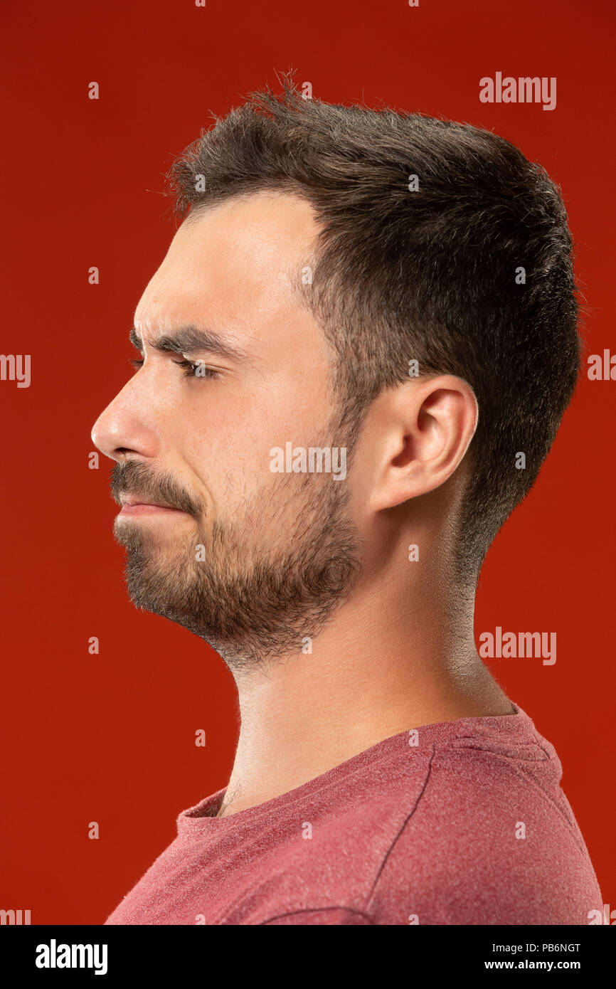 The young emotional angry man screaming on red studio background Stock ...