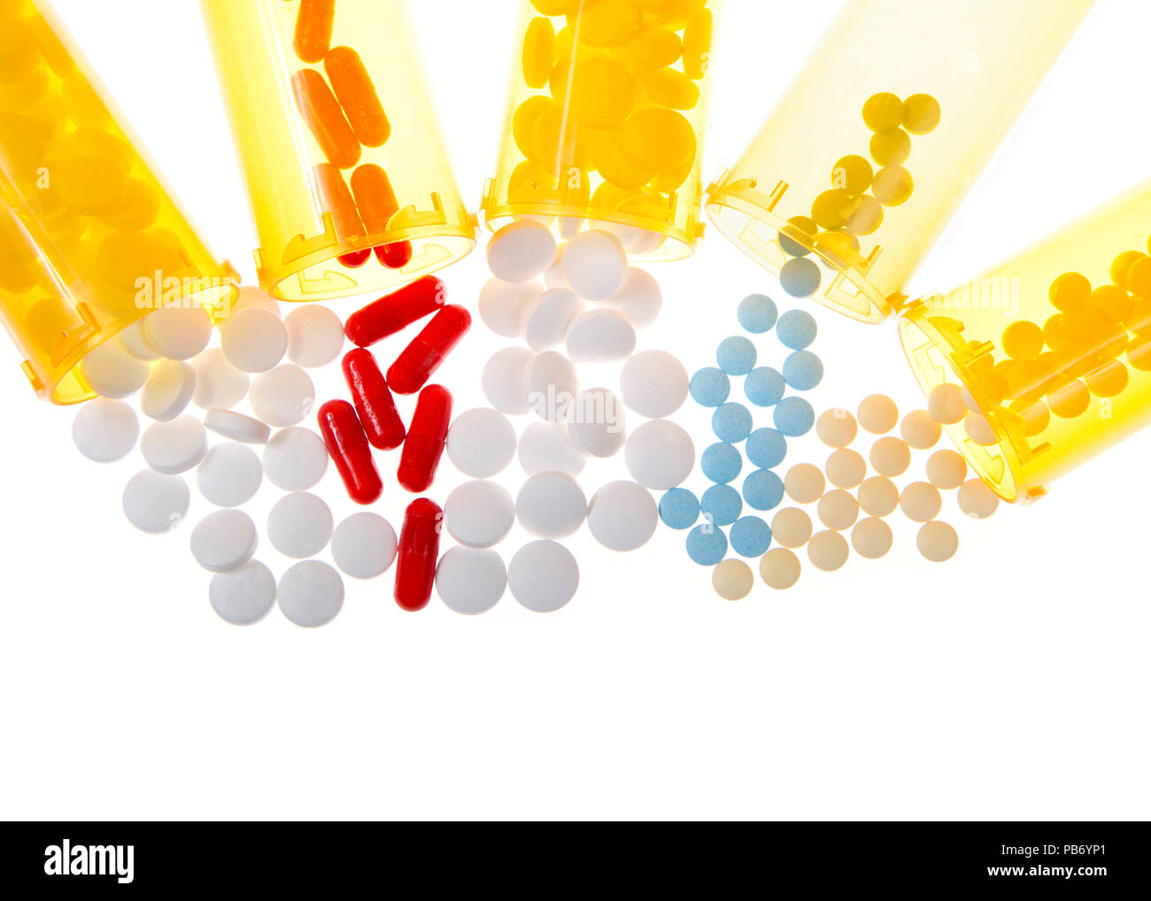 Flat lay top view many medication bottles spilled onto isolated surface ...