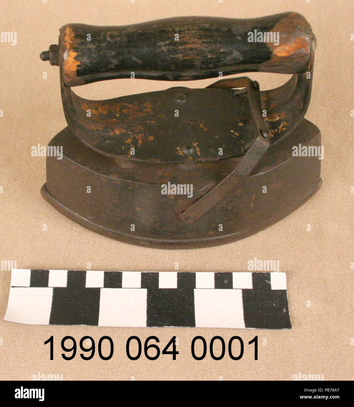 . English: Sad iron, oval-shaped, pointed at both ends, with removeable ...