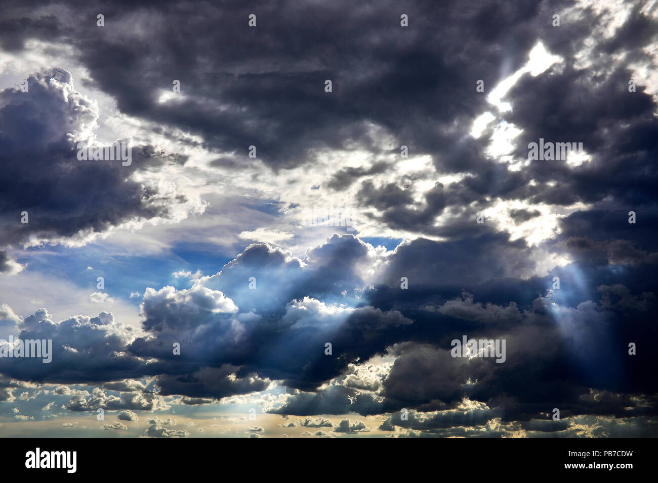 A cloudy sky with sun rays shining through the clouds Stock Photo - Alamy
